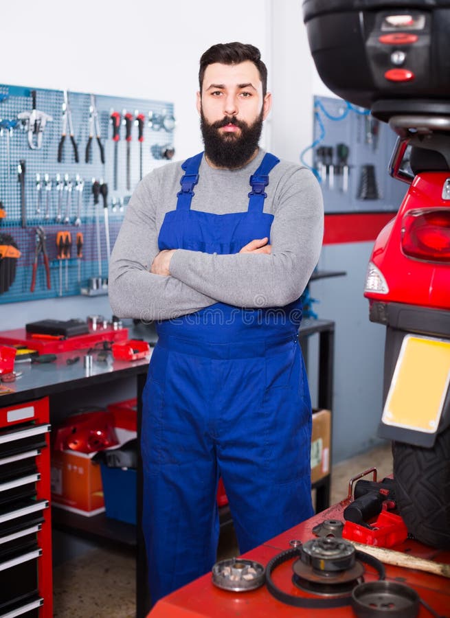 Man Worker Displaying His Workplace in Motorcycle Workshop Stock Image ...