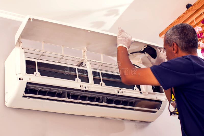 Man Worker Fixing Air Conditioning on the Wall Stock Photo - Image of ...
