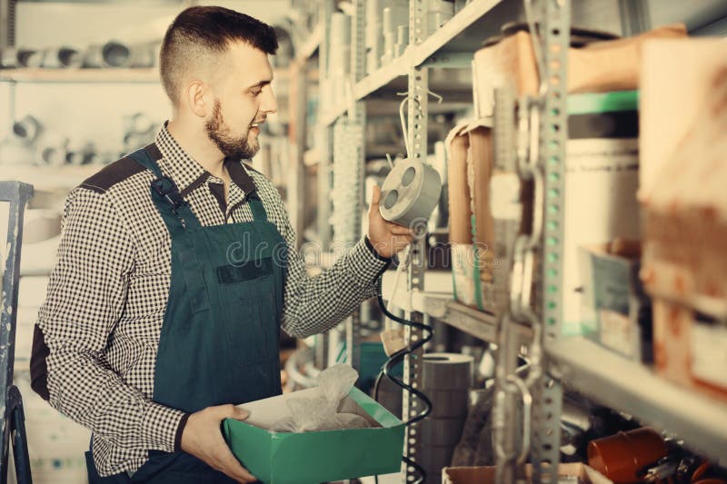 Man Worker Going through Sanitary Engineering Details in Worksho Stock ...