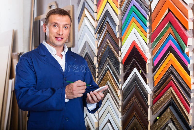 Man Worker Holding Picture Frame Details on Counter Stock Photo - Image ...