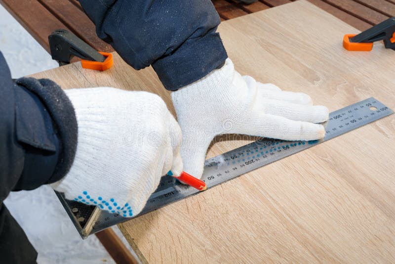 A Man a Worker Draws with a Pencil on a Chipboard Board Stock Photo ...