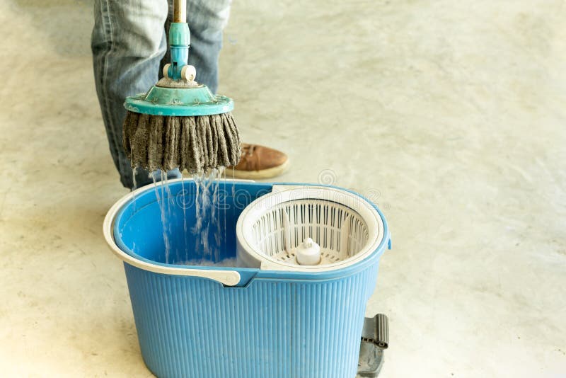 Man Worker with Mop and Bucket Cleaning Floor in the Cafe. Stock Image ...