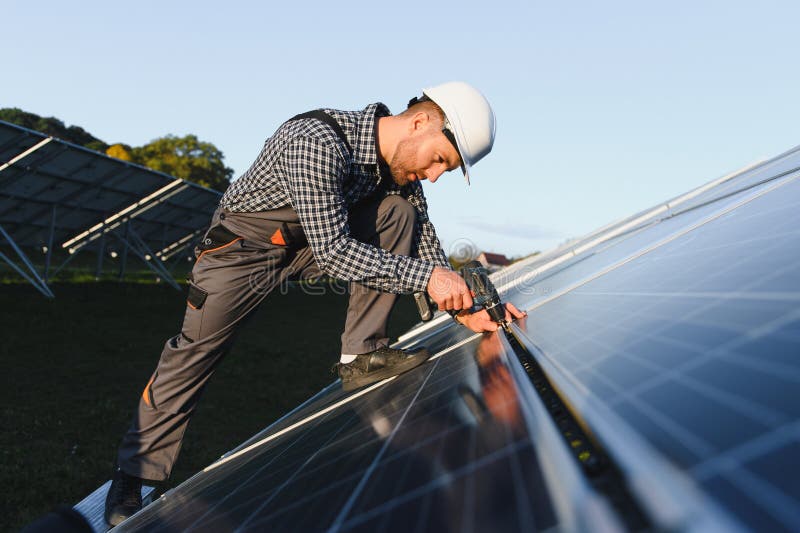 Man Worker Mounting Photovoltaic Solar Panels. Engineer in Helmet ...