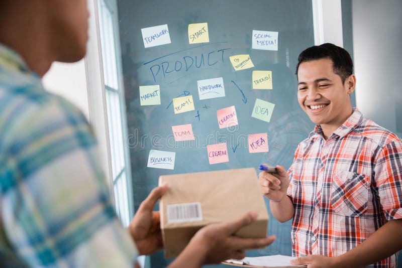A Man Worker Pointing To the Box Held by His Partner for Examples a ...