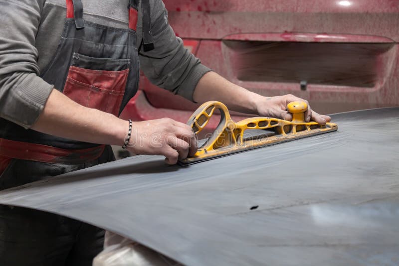 Man Worker Preparing for Painting a Car Element Using Emery Sender by a ...