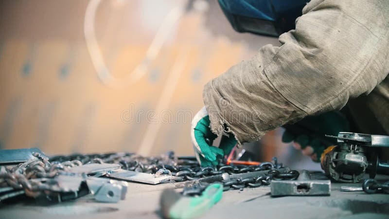 A Man Worker in Protective Helmet Welding a Black Chain Stock Video ...