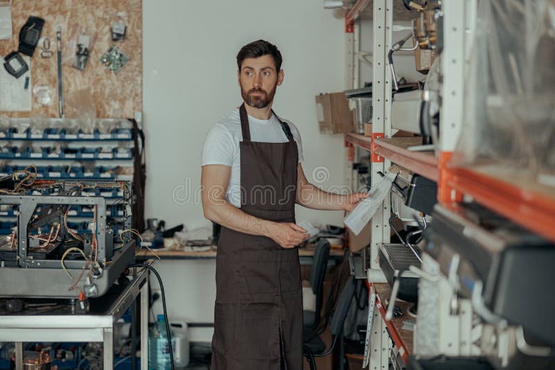 Man Worker in Uniform Inspecting Coffee Machine in Own Workshop Stock ...