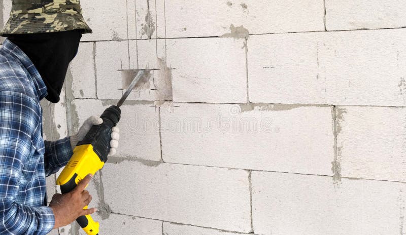 Man Worker Use Yellow Electric Drill Make Block on White Pillar ...