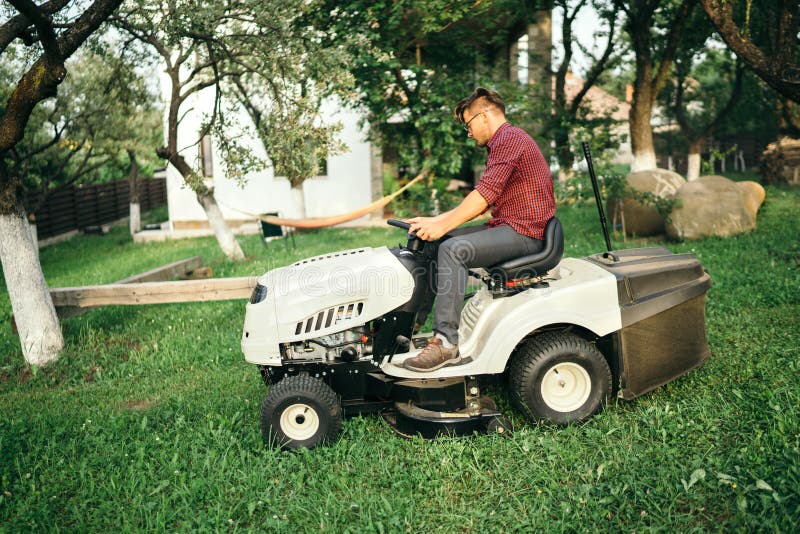 Man Worker Using Garden Lawn Mower and Cutting Grass Stock Image ...