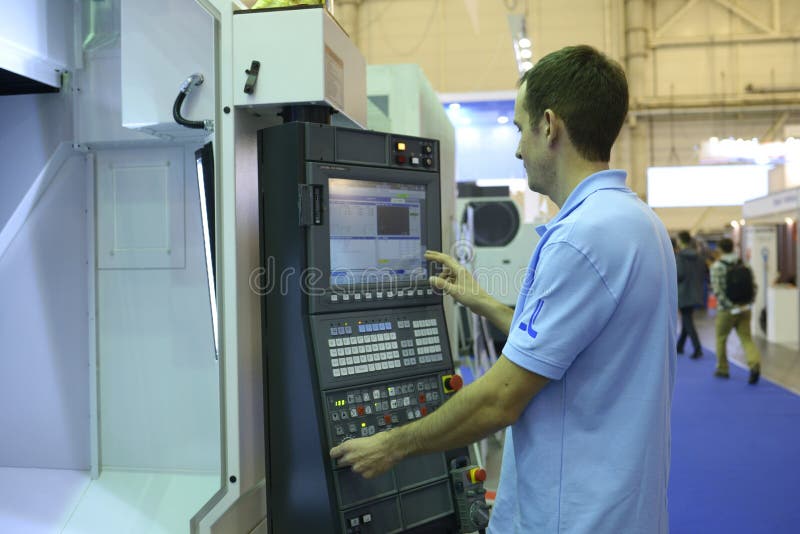 Man Worker Working with a Control Panel of a CNC Milling Machine, Stand ...