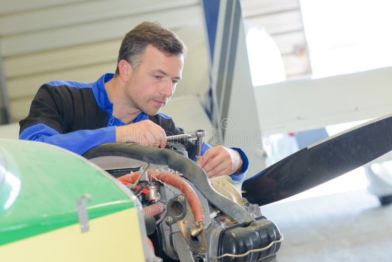 Man working on aircraft stock photo. Image of security - 117894442