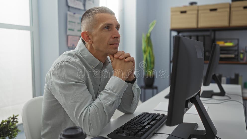 Man Working Alone in Office, Thinking, Focused on Computer, Under ...