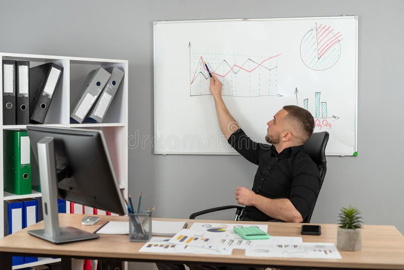 Man Working and Analyzing Financial Reports Project at Modern Office ...
