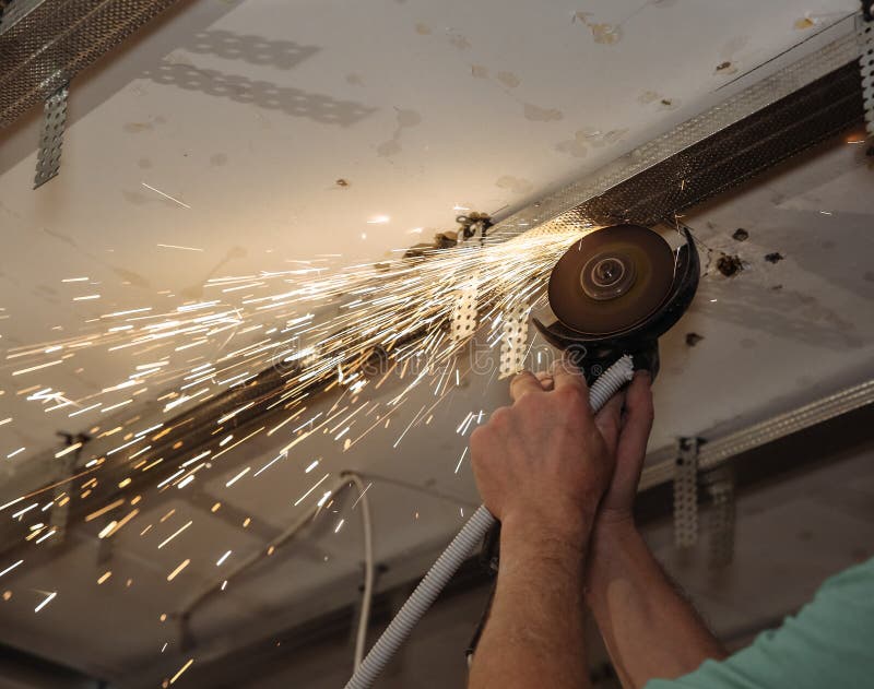 Man is Working with an Angle Grinder and Making Stretch Ceiling ...