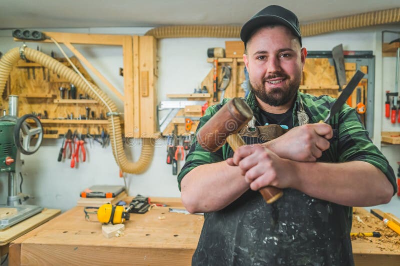 Man Working As Carpenter Posing with Chisel and Mallet in Front of His ...