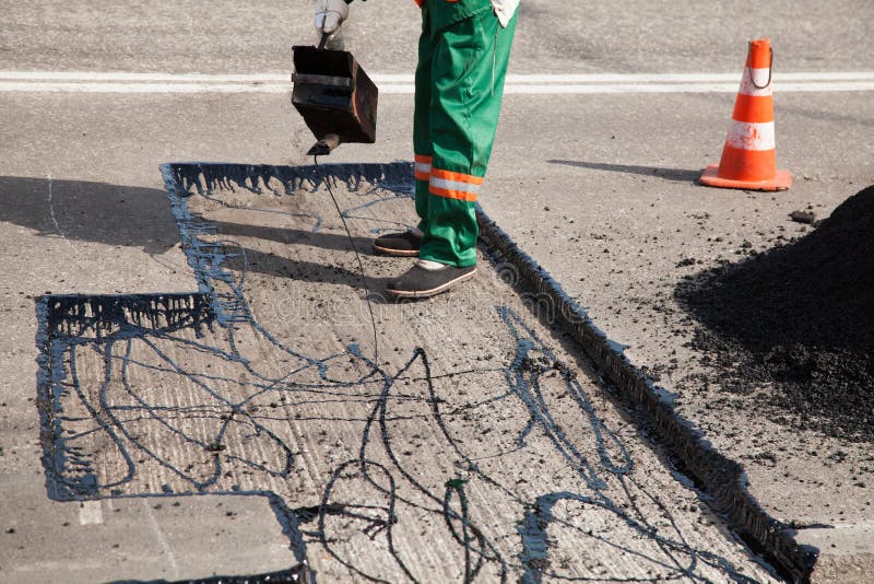 The Man Working Asphalt Pouring Tar for Road Repair. Stock Image ...