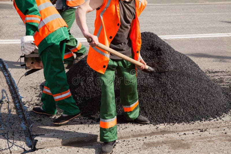 The Man Working Asphalt Pouring Tar for Road Repair. Stock Image ...