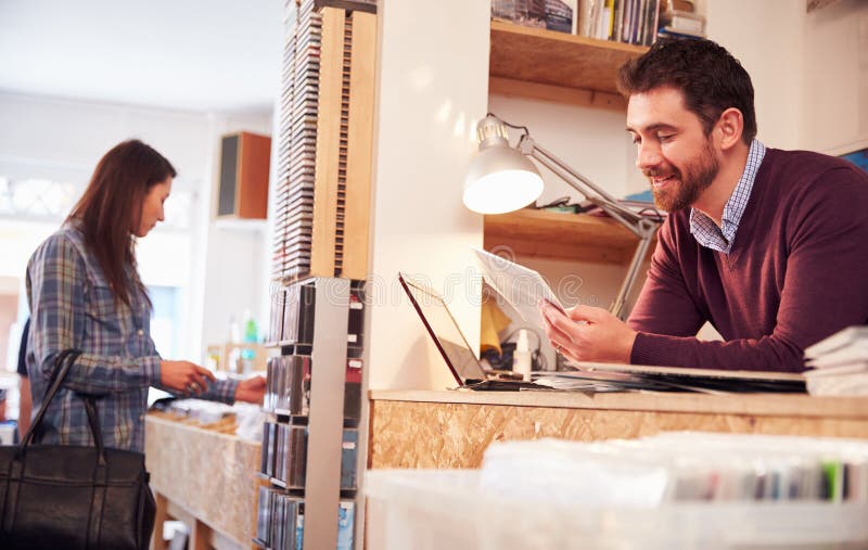 Man Working Behind the Counter at a Record Shop Stock Image - Image of ...