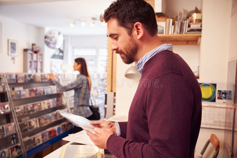 Man Working Behind the Counter at a Record Shop Stock Photo - Image of ...