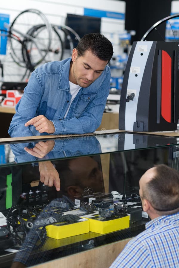 Man Working in Bike Rental Shop and Customer Asking Stock Photo - Image ...