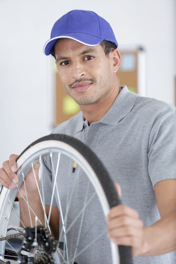 Man Working in Bike Workshop Stock Image - Image of smiling, cover ...
