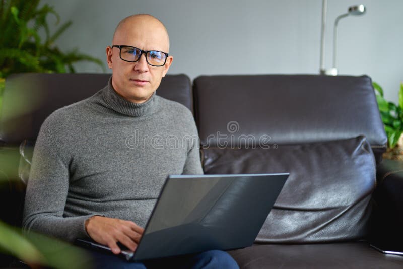 Man Working on a Blank Laptop on a Comfortable Sofa at Home. Stock ...