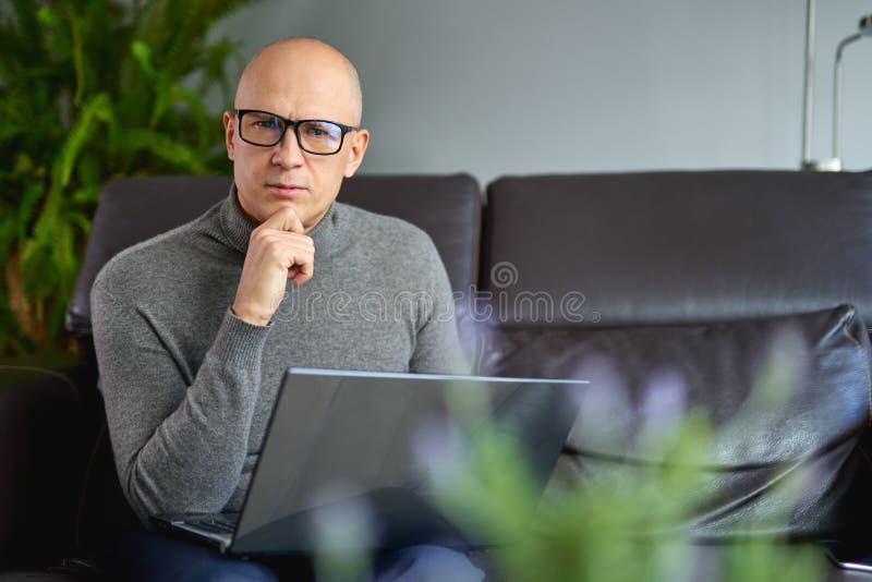 Man Working on a Blank Laptop on a Comfortable Sofa at Home. Stock ...