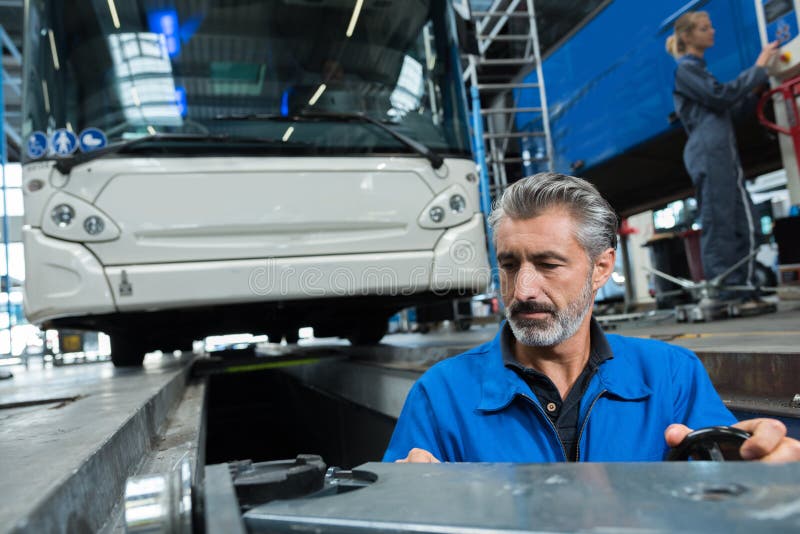 Man working in bus garage stock photo. Image of automobile - 266082384