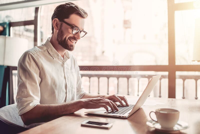 Man working in cafe stock image. Image of laptop, eyeglasses - 94187601