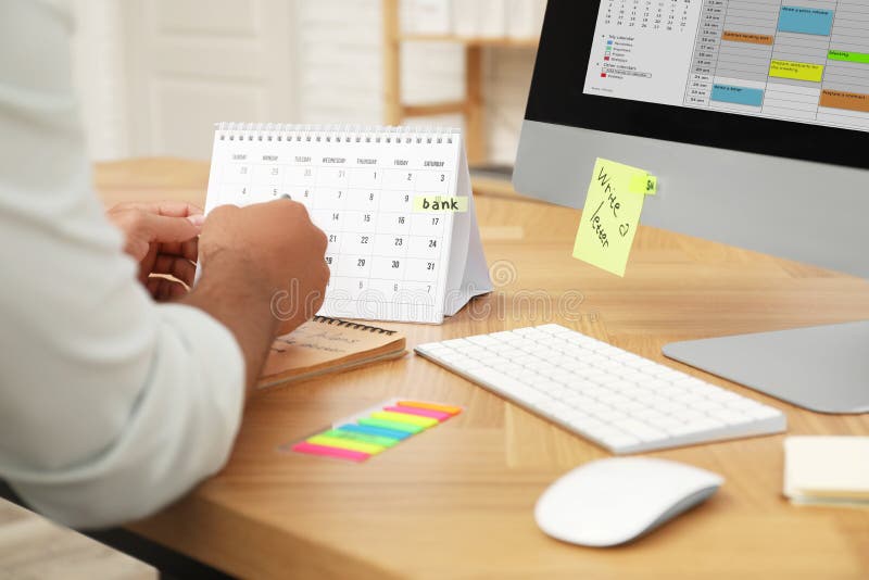 Man Working with Calendar at Table in Office Stock Image - Image of ...