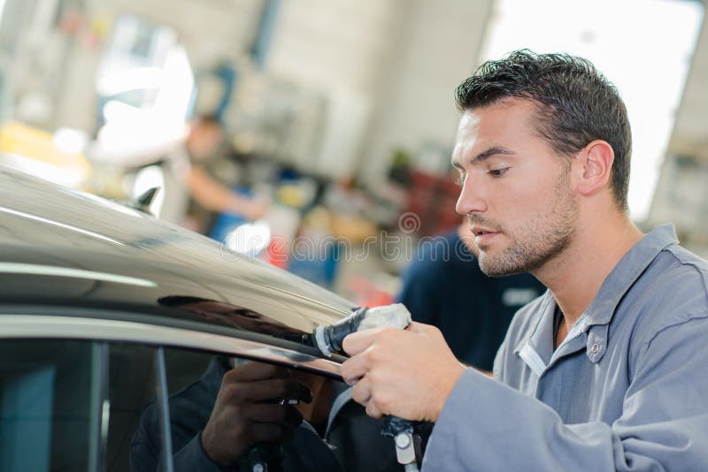 Man working on car body stock photo. Image of sealing - 95053380