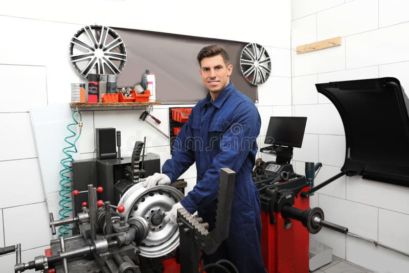 Man Working with Car Disk Lathe Machine at Service Stock Photo - Image ...