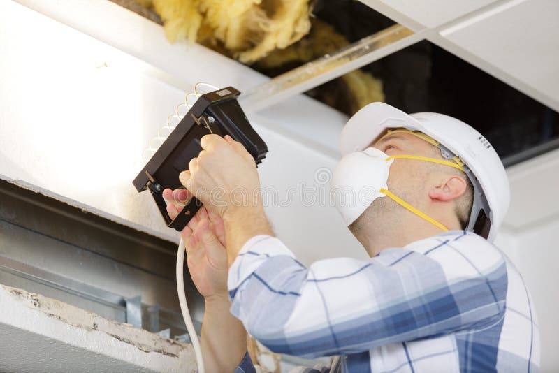 Man working in ceiling stock photo. Image of electrical - 200447444