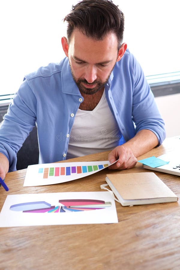 Man Working on Charts and Graphs at His Desk Stock Photo - Image of ...