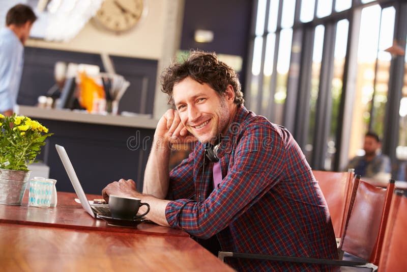 Man Working on Computer at Coffee Shop, Portrait Stock Image - Image of ...