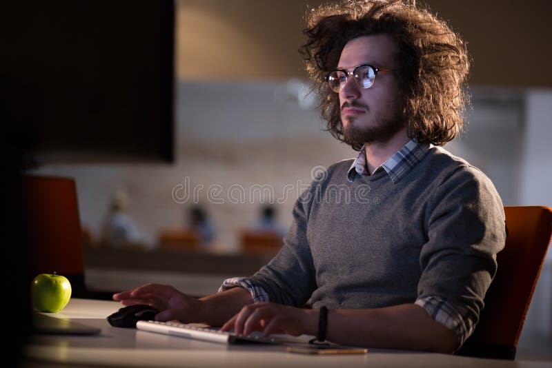 Man Working on Computer in Dark Office Stock Image - Image of graphic ...