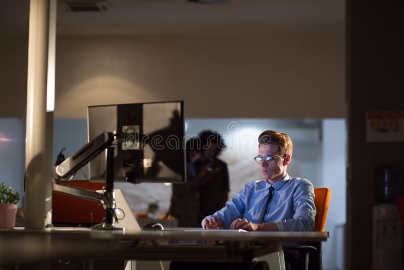 Man Working on Computer in Dark Office Stock Image - Image of people ...
