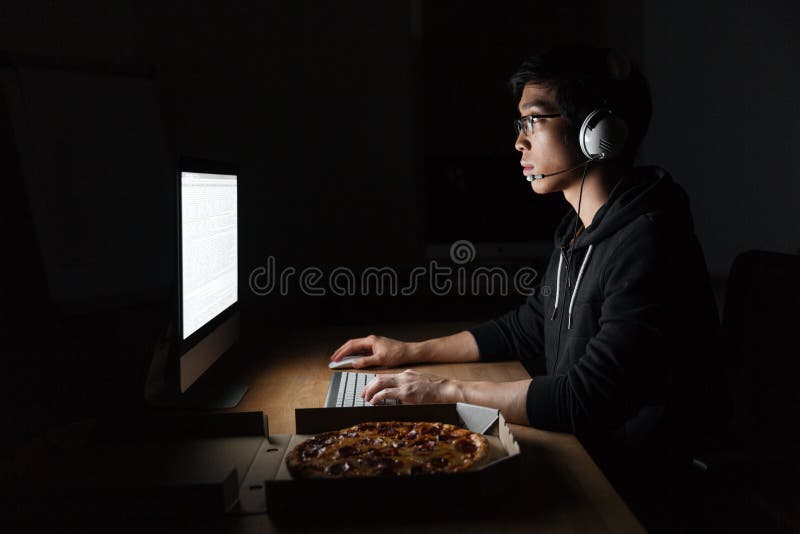 Man Working with Computer and Eating Pizza in Dark Room Stock Photo ...