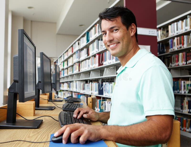 Man Working on Computer in Library Stock Photo - Image of people ...