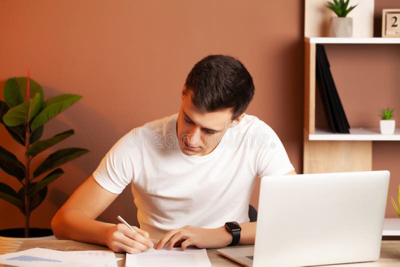 Man Working at the Computer in the Office and Filling Documents Stock ...