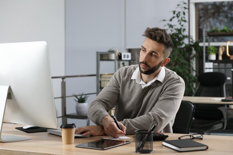 Man Working on Computer at Table in Office Stock Photo - Image of adult ...