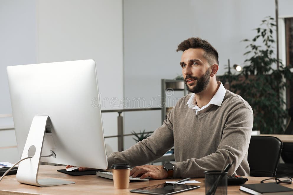 Man Working on Computer at Table in Office Stock Image - Image of ...
