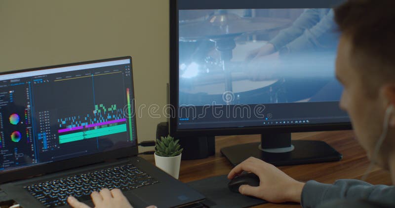 Man Working on Computer with Two Monitors Video Editing. Monitor the ...