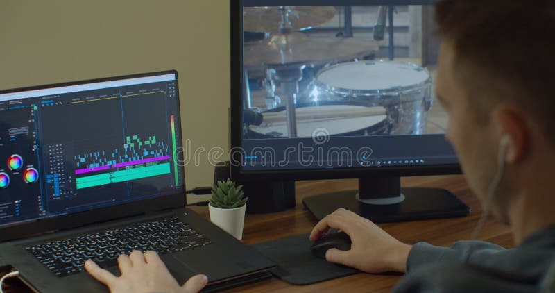 Man Working on Computer with Two Monitors Video Editing. Monitor the ...