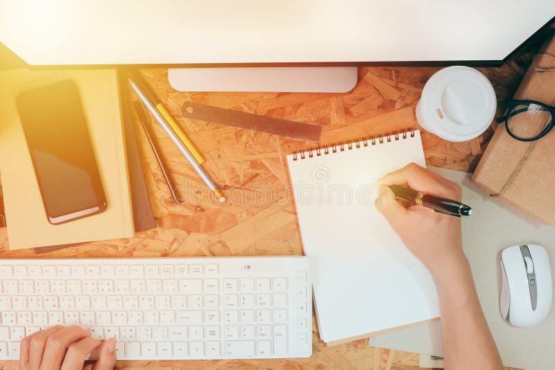 Man Working with Computer Typing Keyboard and Writing Pen on Notebook ...