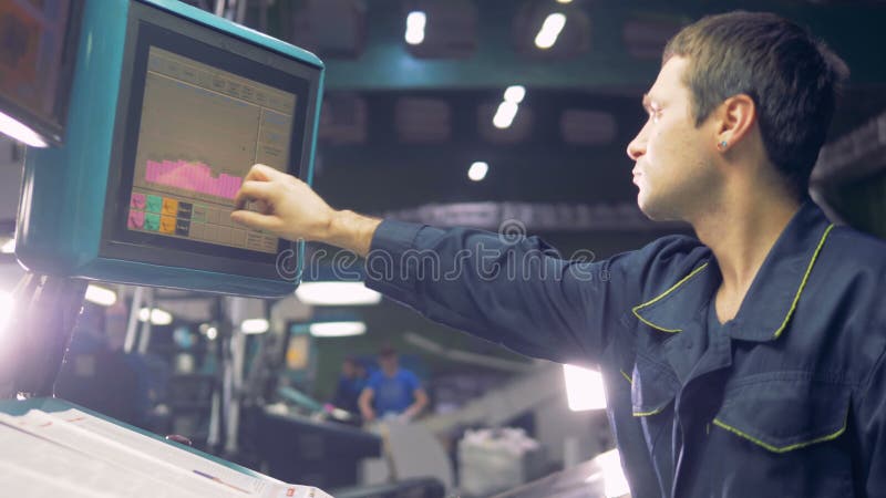 Man Working with Computerized Machine Operating with Factory Line at ...