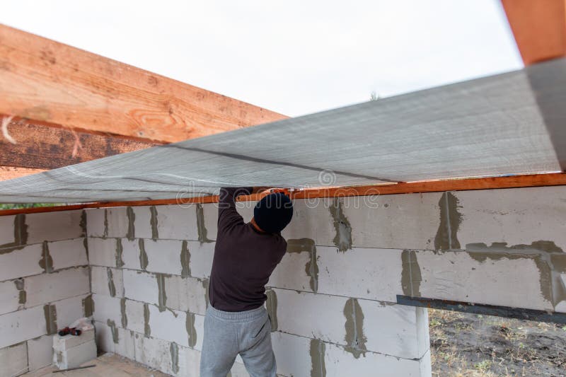 A Man is Working on a Construction Site, Fixing a Ceiling Stock Photo ...
