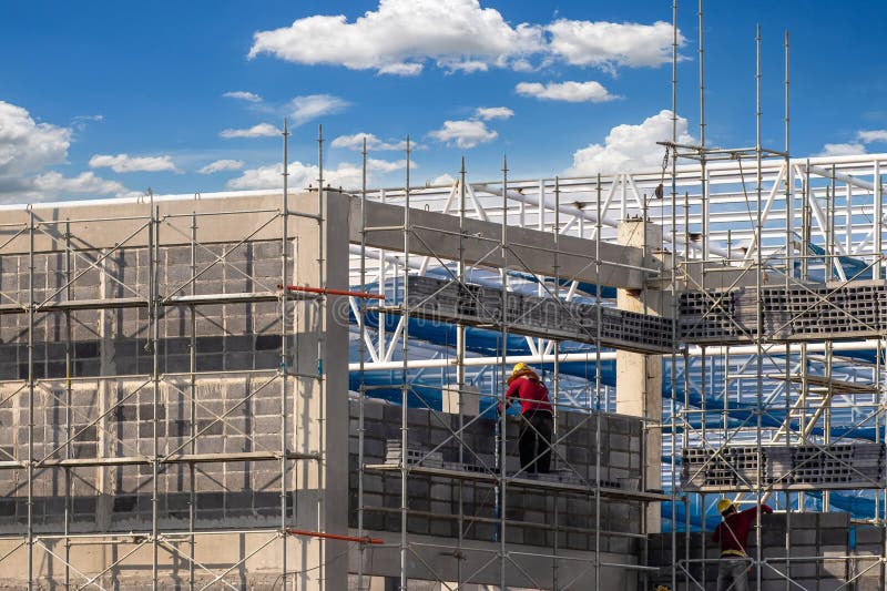 Man Working on Construction Site with Scaffold and Building with Sky ...