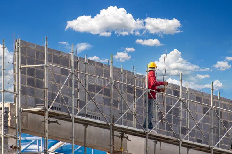 Man Working on Construction Site with Scaffold and Building with Sky ...