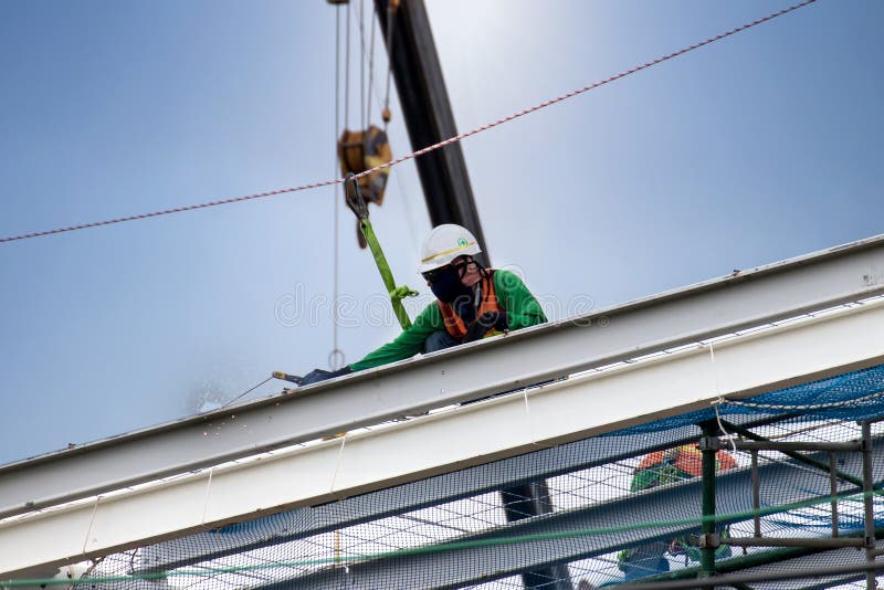 Man Working on Construction Site with Scaffold and Building with Sun ...